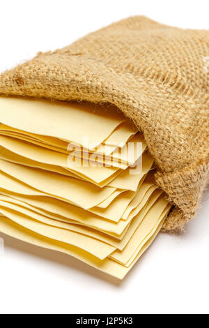 Cooking lasagna. Pasta sheets in baking tray and products on dark ...