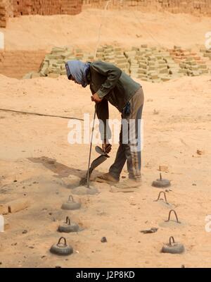 Indian labors working at a brick factory on the eve of International ...