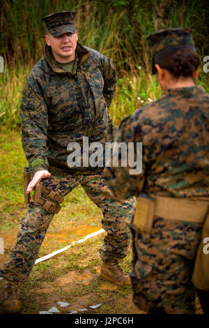 Capt. Troy D. Goss provides feedback to 2nd Lt. Jennifer N. Galvan ...