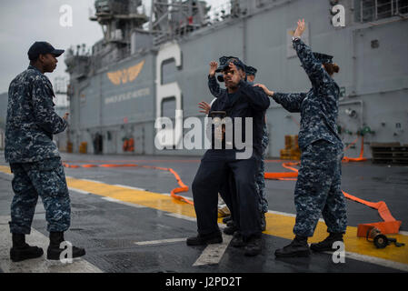 Air department personnel conduct a firefighting drill on USS Kitty Hawk ...