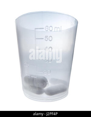 plastic cup with dose of tablets in hand isolated on white background ...