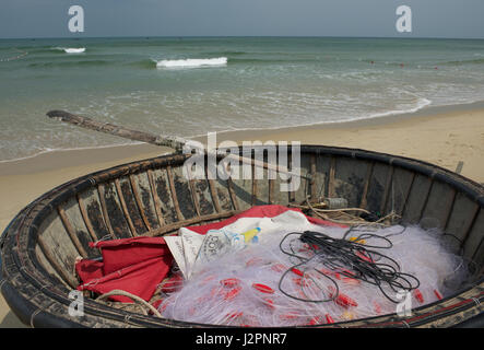 A round coracle, a traditional boat made of willow withies covered with ...