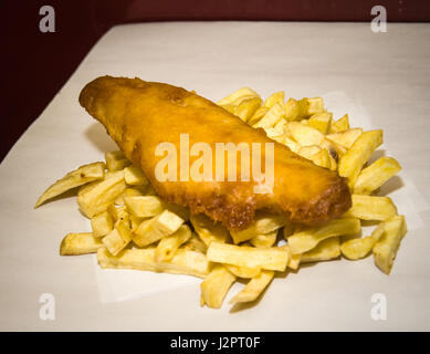 Chip shop chips in their paper wrapping Stock Photo - Alamy