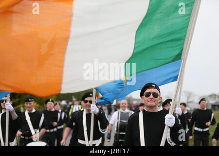 A flag-bearer carries the Irish tricolour during a march to Cappagh, Co ...