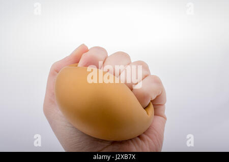 Squeezing yellow balloon with hand on a white background Stock Photo ...