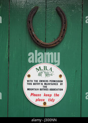 Mountain bothies association (MBA) sign on the open door of Doune Byre ...