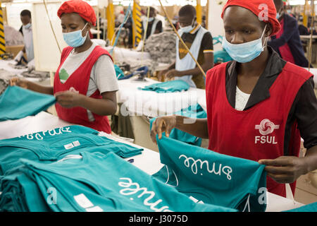 Textile workers producing fabric and clothing at a factory in Kampala ...