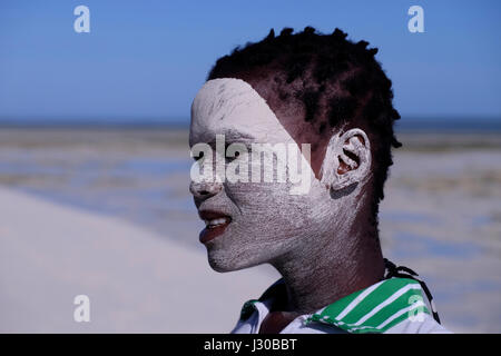 A young Mwani woman with her face covered with a natural white mask to ...