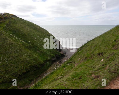 The footpath through the gully onto the beach at Fleswick Bay, Cumbria ...