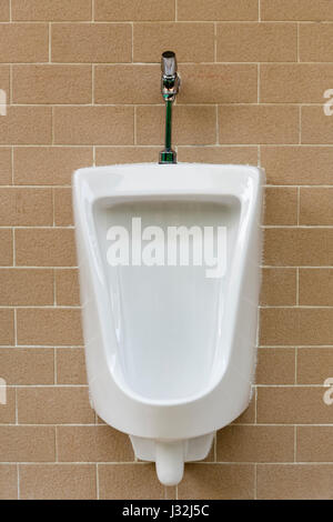 White urinal for men on brick wall in public toilet Stock Photo - Alamy