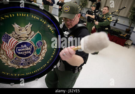 A members of the U.S. Border Patrol Pipes and Drums plays his bagpipes ...
