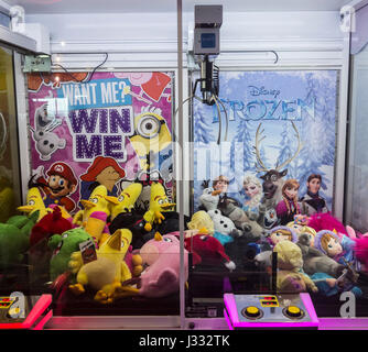 Toy grab claw machine at a funfair arcade Stock Photo - Alamy