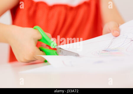 Child's hands cutting paper with scissors closeup Stock Photo - Alamy