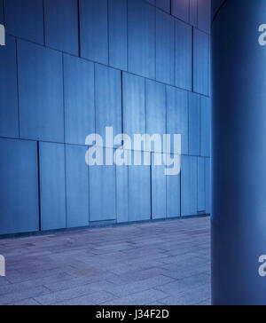 Fragment of a gray concrete wall with metal structures Stock Photo - Alamy