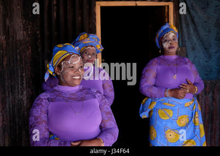 African women with their faces covered with a natural white mask called ...