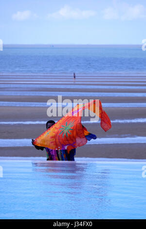 A capulana also spelled "Kapulana," a type of a sarong fabric worn ...