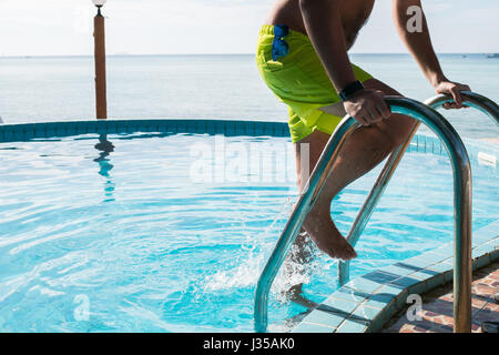 man coming out of swimming pool Stock Photo - Alamy