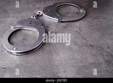 German police handcuffs on rough grey background with copy space Stock ...