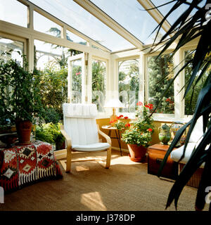 Interior of a bright sunlit conservatory with glass windows, tables ...