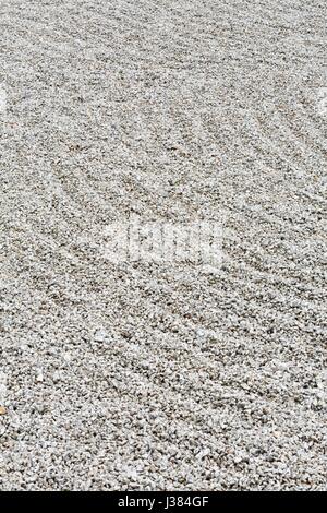 Circular raked gravel pattern in a zen garden Stock Photo - Alamy