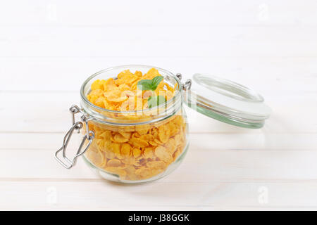 Jar of corn flakes for breakfast on wooden surface Stock Photo - Alamy
