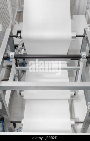 paper rolling machine, white paper on roll Stock Photo - Alamy