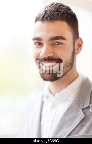 Serious handsome man posing and looking at camera isolated over yellow ...