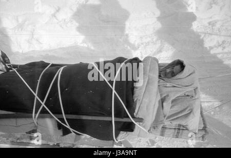 Rescued avalanche victim on a rescue sled after an avalanche in Blons ...