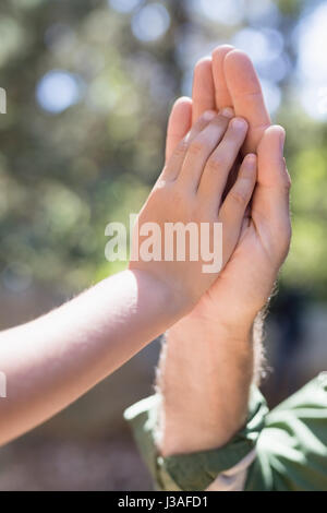 Family high five with hands raised up sitting on sofa at home Stock ...