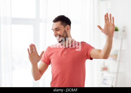 man touching something imaginary at home Stock Photo - Alamy