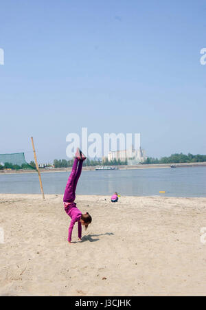 Girl doing a handstand and backflip in front Stock Photo - Alamy