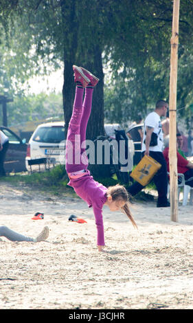 Girl doing a handstand and backflip in front Stock Photo - Alamy