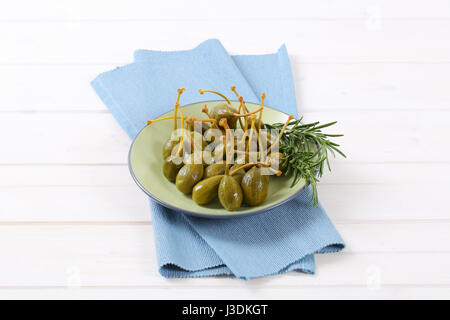 plate of pickled caper berries with stems on Stock Photo - Alamy