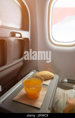 Set of inflight meal in a box, on the folding table in economy class ...