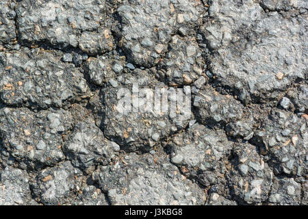 Broken alligator cracked tarmac road surface. For falling apart ...