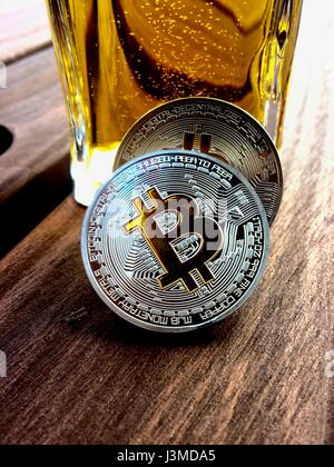 Digital currency physical silver bitcoin coin on white keyboard in ...