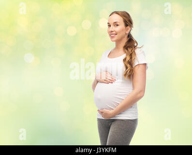 happy pregnant woman touching her big belly Stock Photo - Alamy