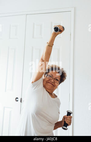 Older woman using dumbbells Stock Photo - Alamy