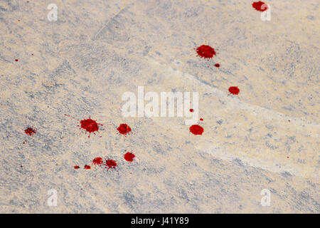 Splatters of fresh human bright red blood on a concrete surface Stock ...