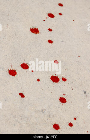 Splatters of fresh human bright red blood on a concrete surface Stock ...