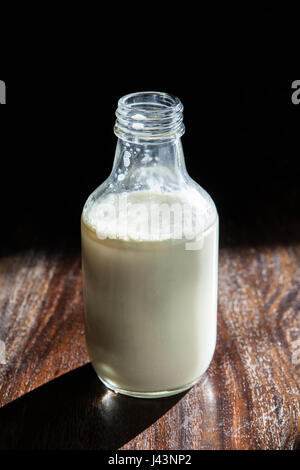 Milk in an old fashioned antique milk bottle Stock Photo - Alamy