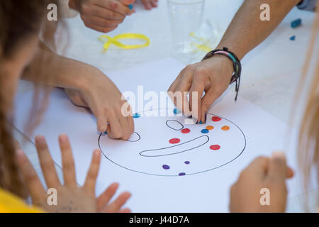 Kids playing with play doh Stock Photo - Alamy