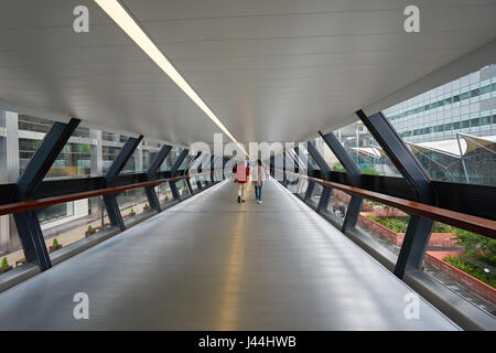 People walking inside of the pedestrian skybridge of Copley Place.Back ...