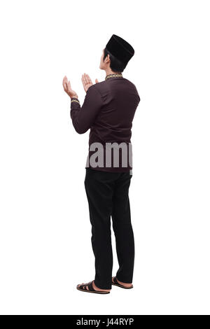 Back view of asian muslim man with cap praying isolated over white ...