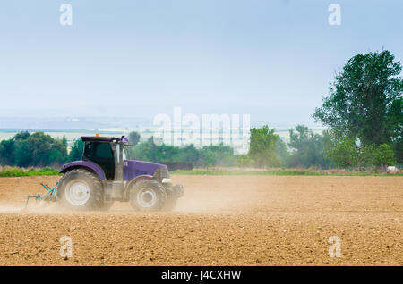 Tractor preparing land for sowing Stock Photo - Alamy