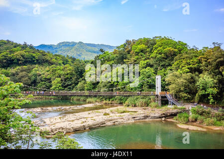 beautiful spring landscape with a cable bridge over the river. River ...