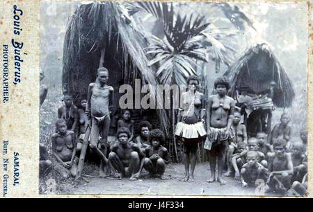 Group of natives outside village houses British New Guinea Stock Photo ...
