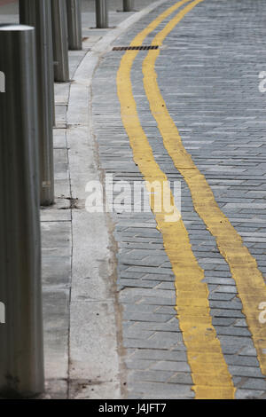 Road gutter with double yellow lines, UK Stock Photo - Alamy