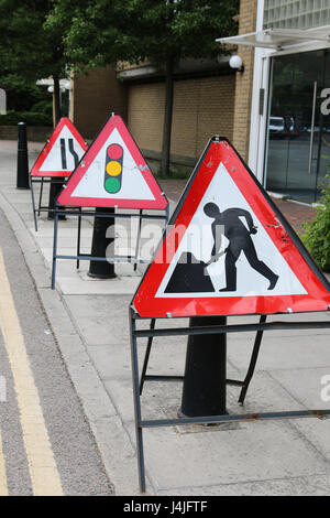 Warning signs, road works men at work traffic sign isolated over ...