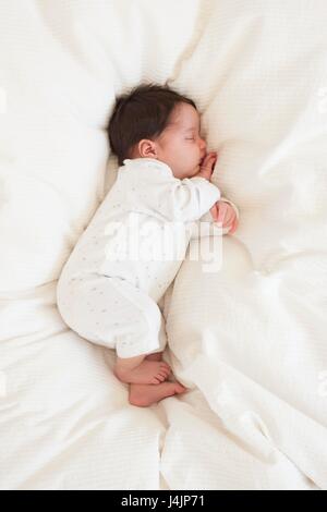 newborn baby lying on bed in bedroom . photo with copy space Stock ...